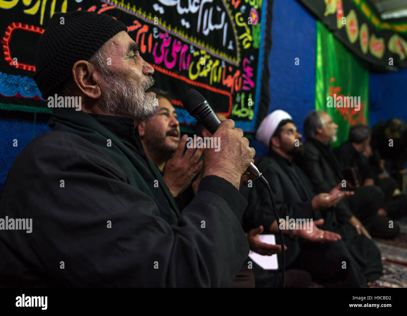 Iranian shiite muslim men listening to a mullah who preaches during ...