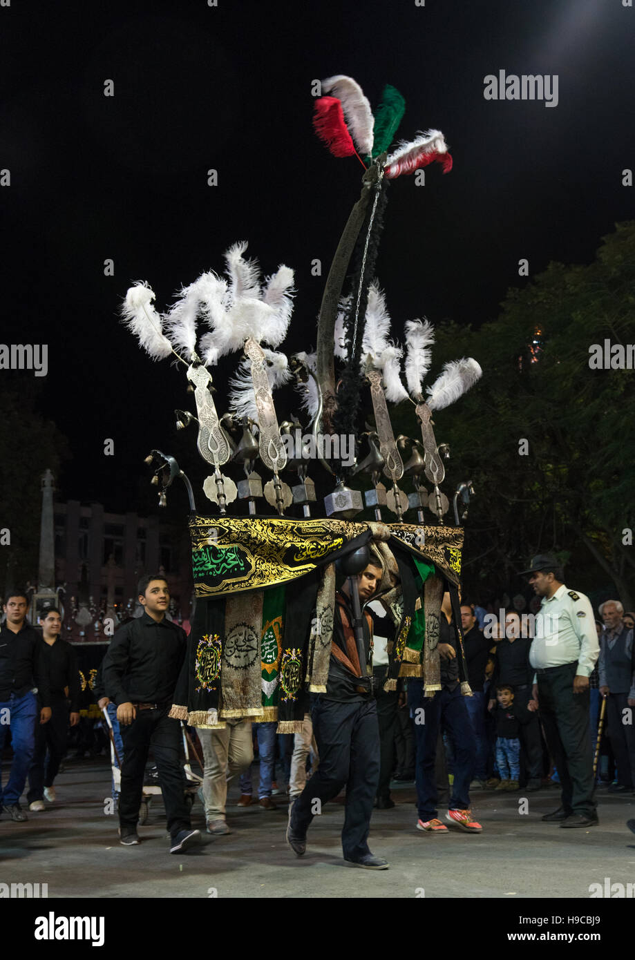 Iranian shiite muslim children carrying an alam during muharram ...