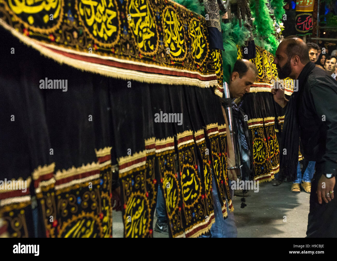 Iranian shiite muslim men carrying an alam during muharram, Lorestan ...