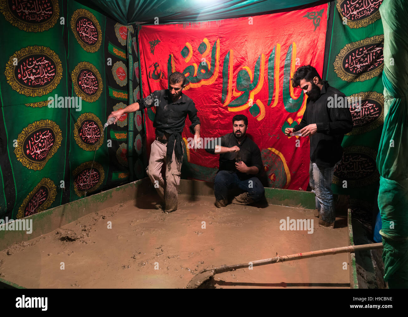 Iranian shiite muslim men prepare a mud pond for the kharrah mali ...