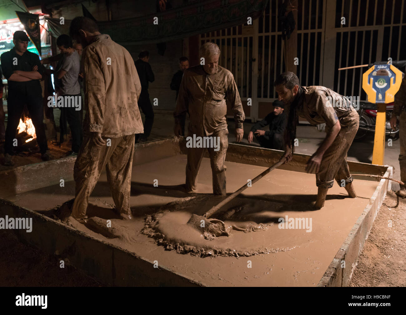 Iranian shiite muslim men prepare a mud pond for the kharrah mali ...