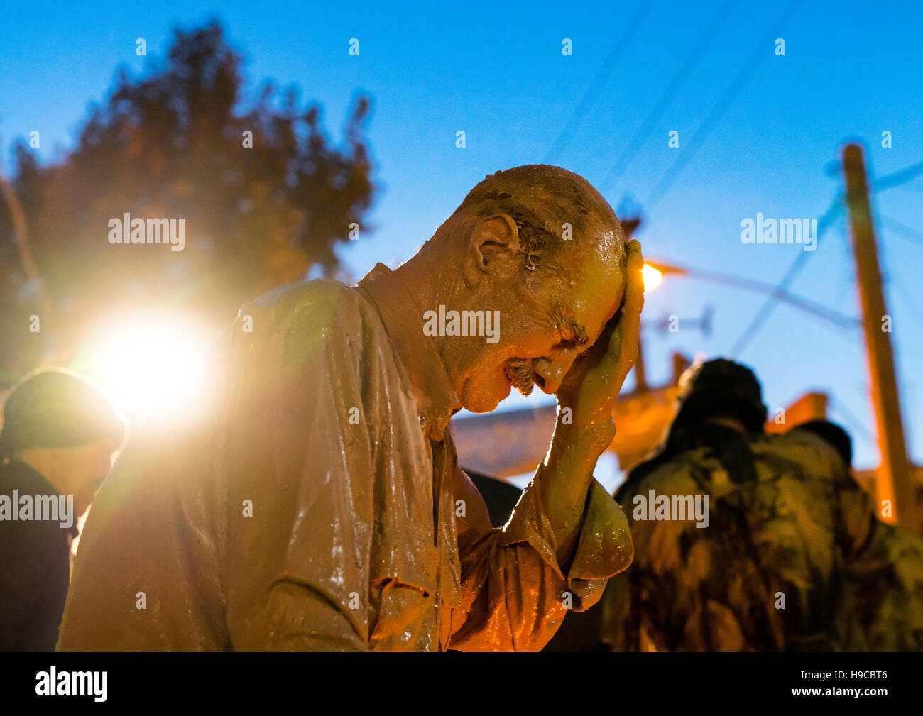Iranian shiite muslim man crying after rubbing mud on his body during ...