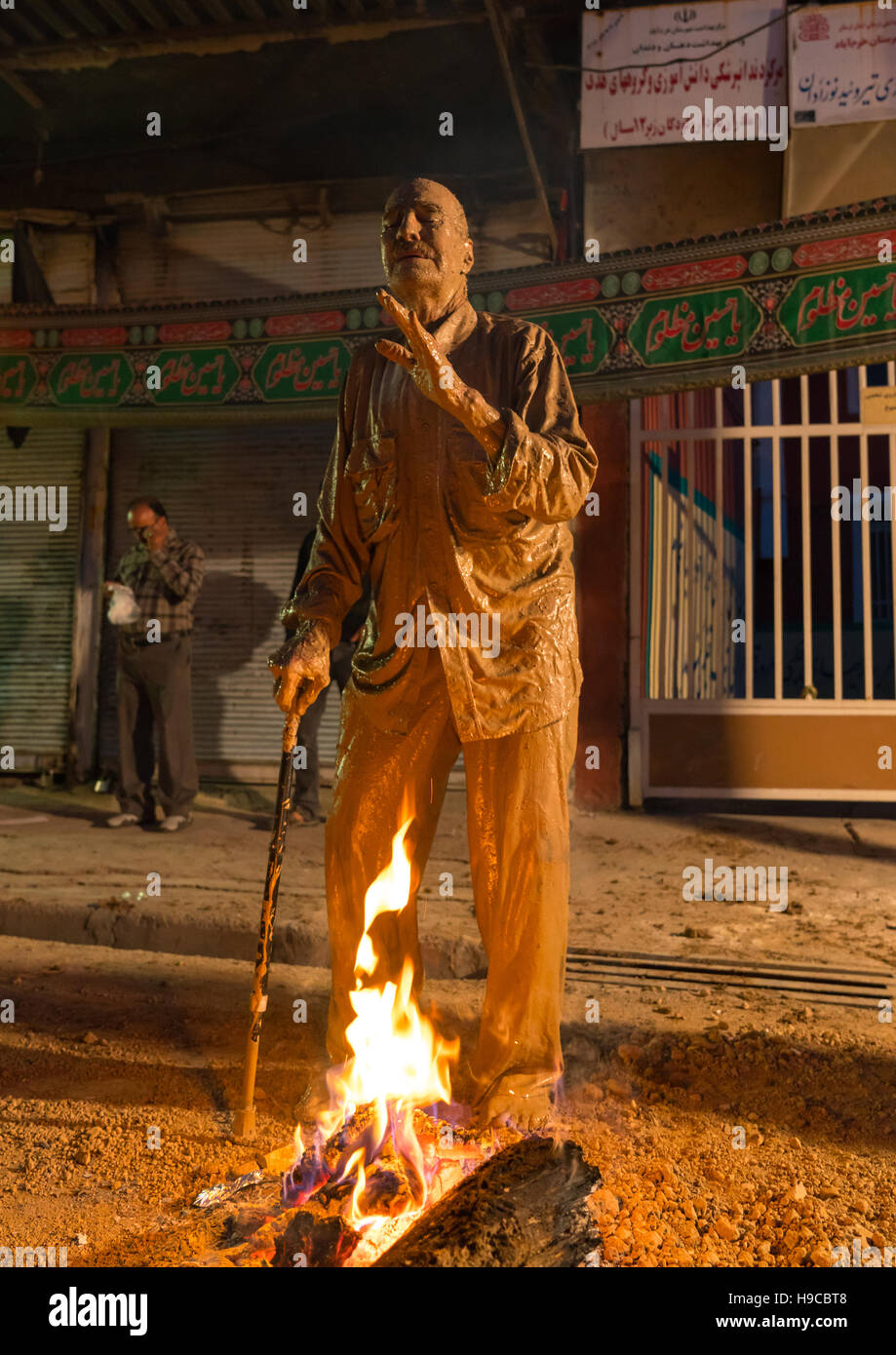 Iranian shiite muslim man standing in front of a bonfire after rubbing ...
