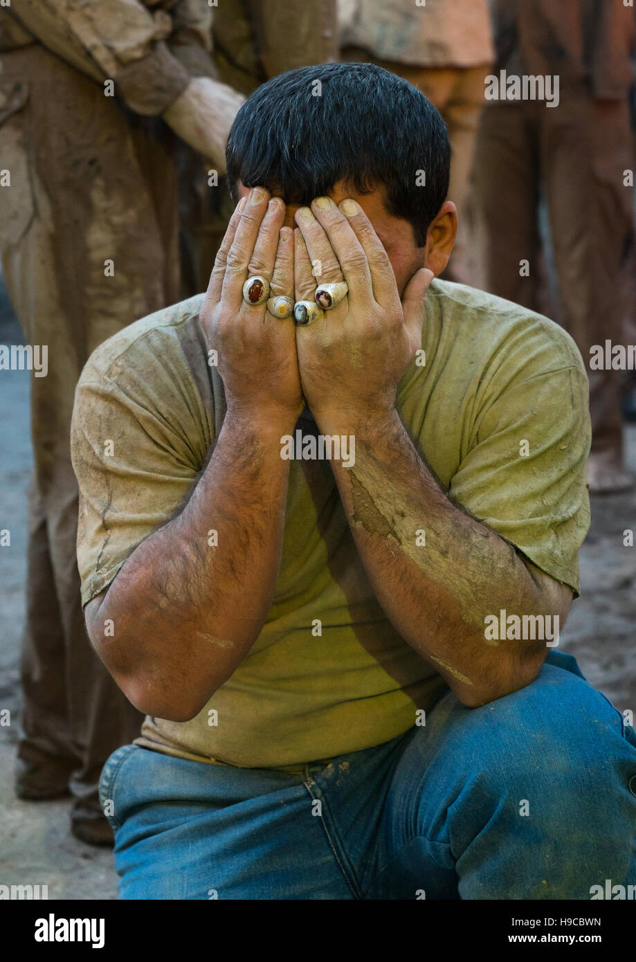 Iranian shiite muslim man crying after rubbing mud on his body during ...