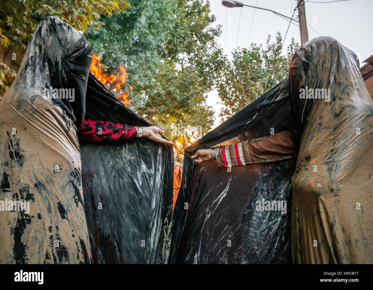 Iranian shiite muslim women gather around a bonfire after rubbing mud ...