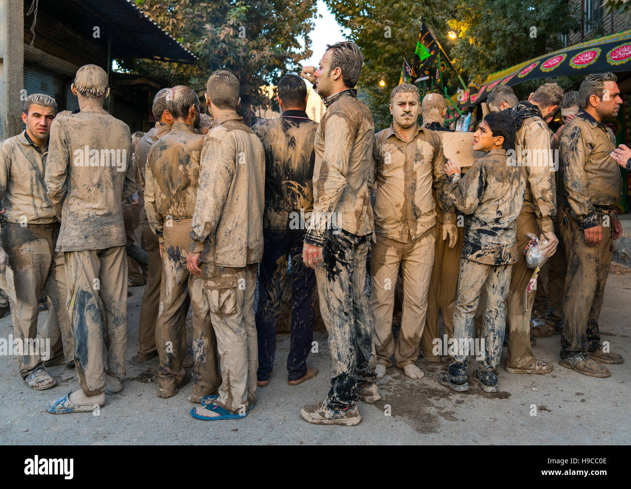 Iranian shiite muslim men gather around a bonfire after rubbing mud on ...