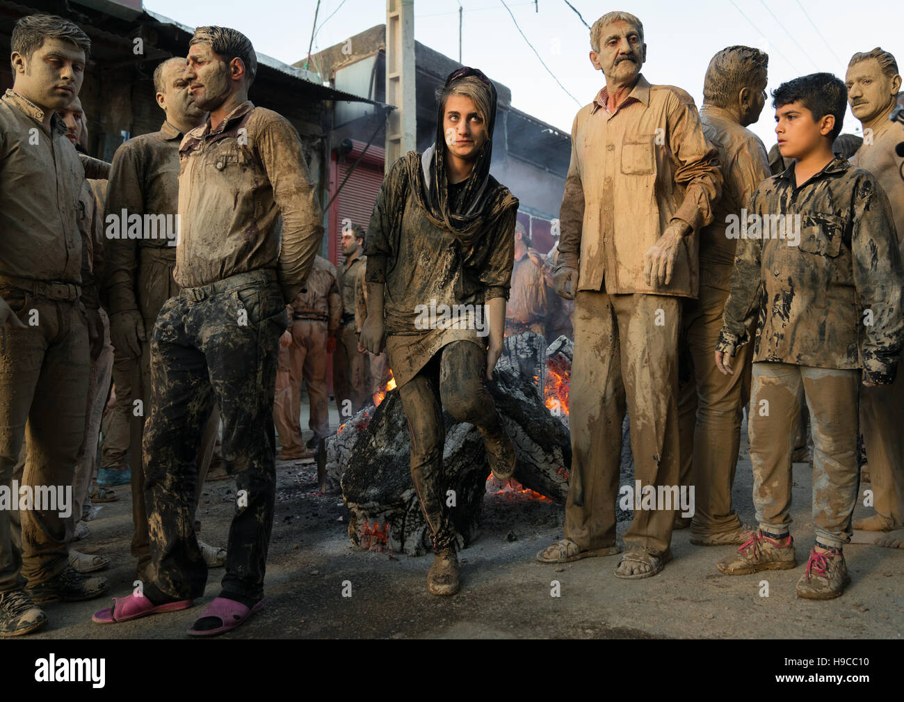 Iranian shiite muslim men gather around a bonfire after rubbing mud on ...