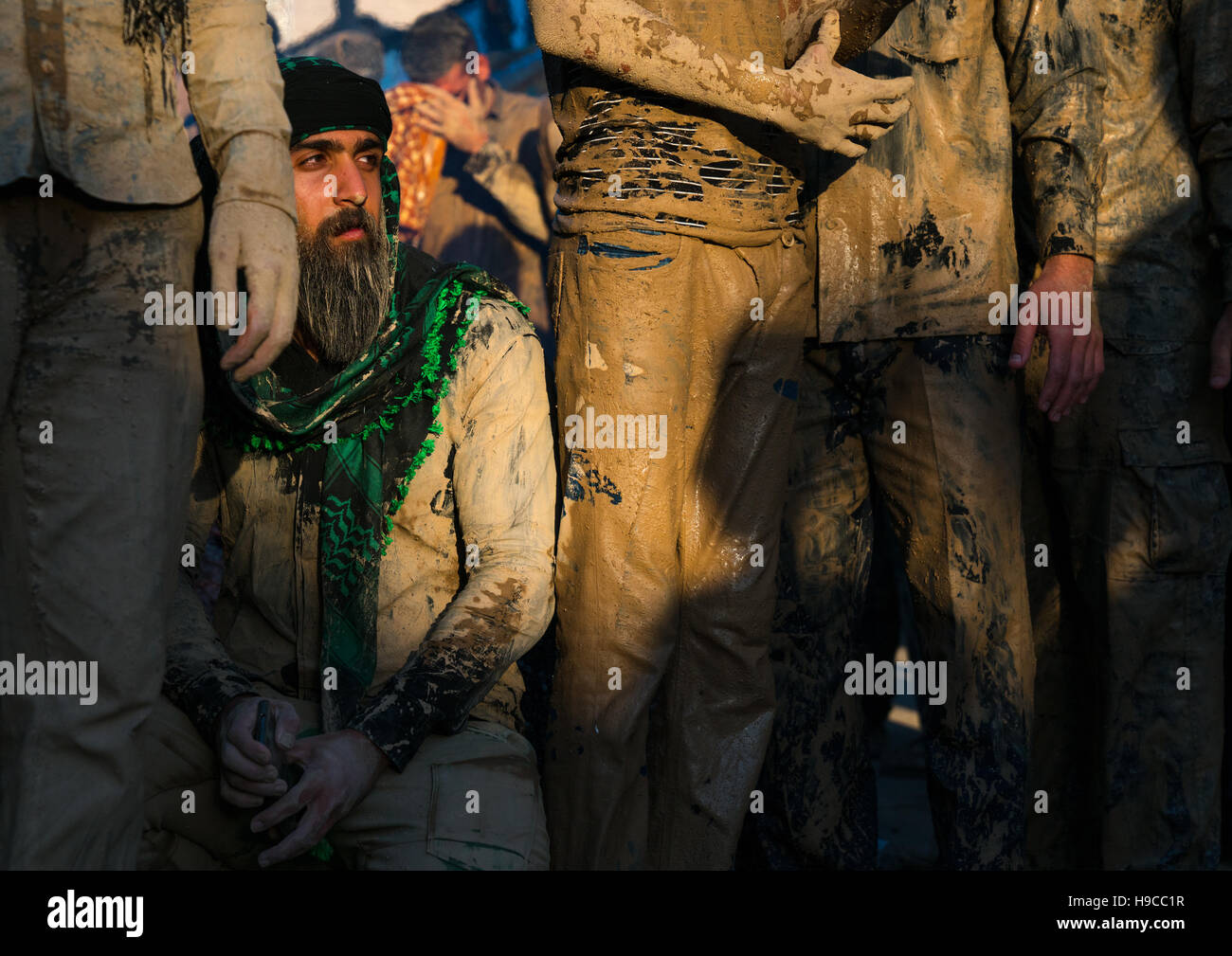 Iranian shiite muslim men gather around a bonfire after rubbing mud on ...