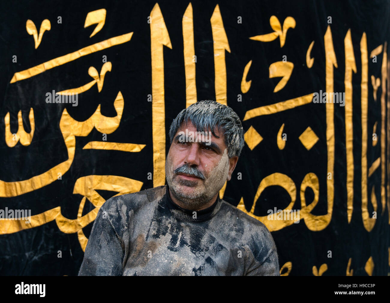 Iranian shiite muslim man after rubbing mud on his body during the ...