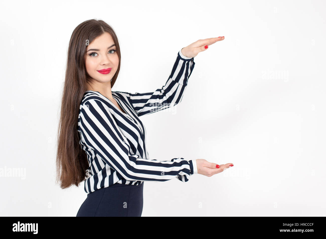 Beautiful elegant Woman showing product .Beautiful girl pointing to the ...