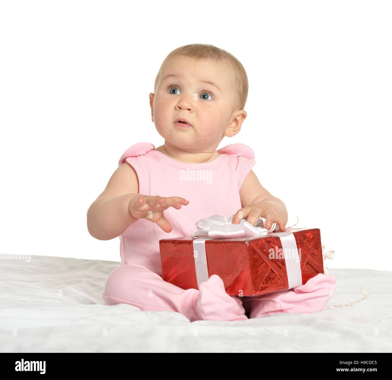 Baby girl sitting with gift Stock Photo - Alamy