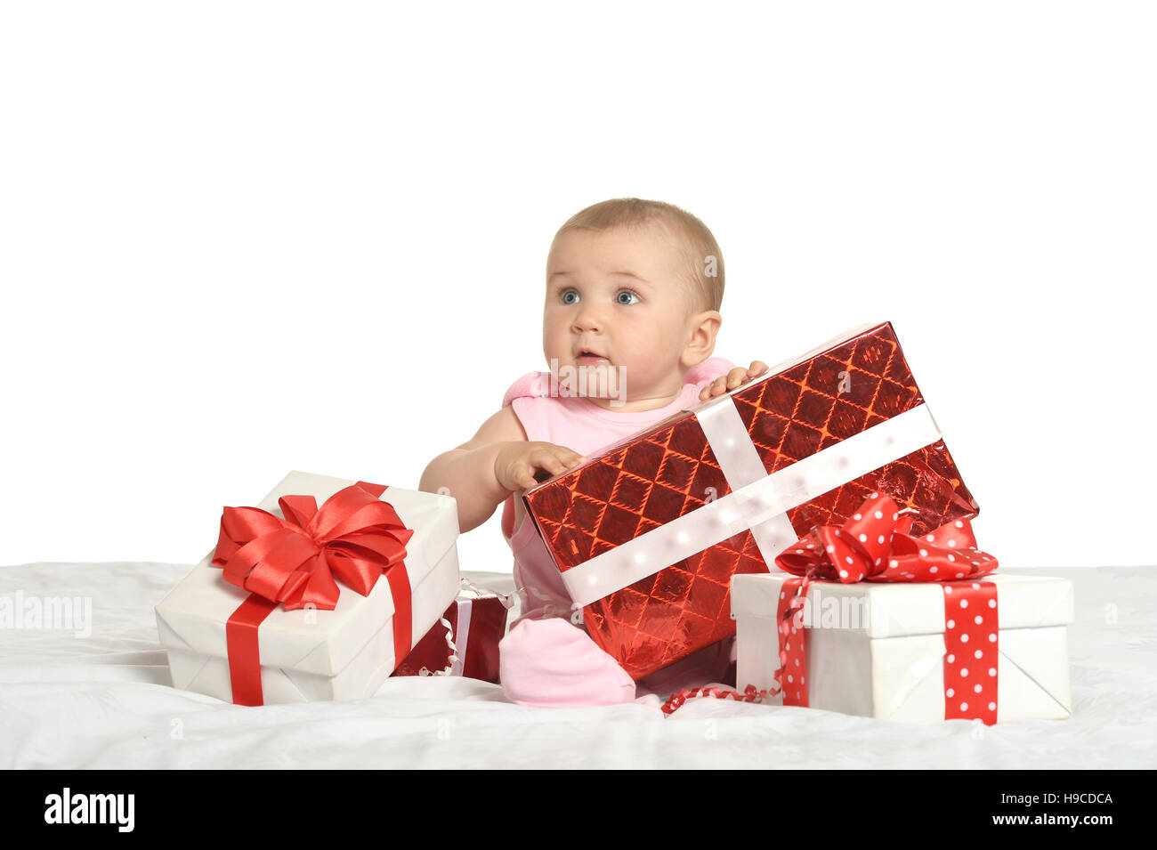 Baby girl sitting with gifts Stock Photo - Alamy