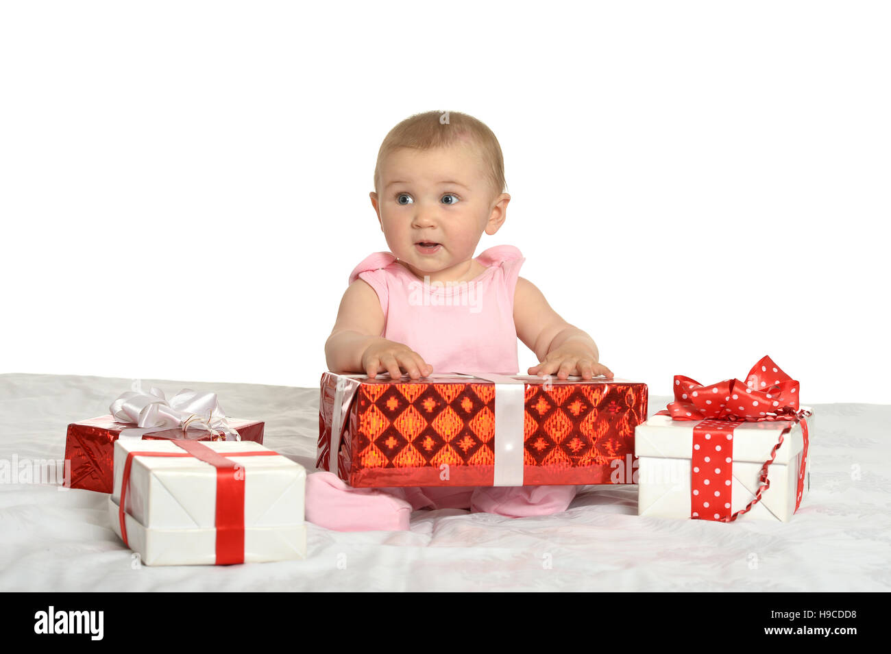 Baby girl sitting with gifts Stock Photo - Alamy