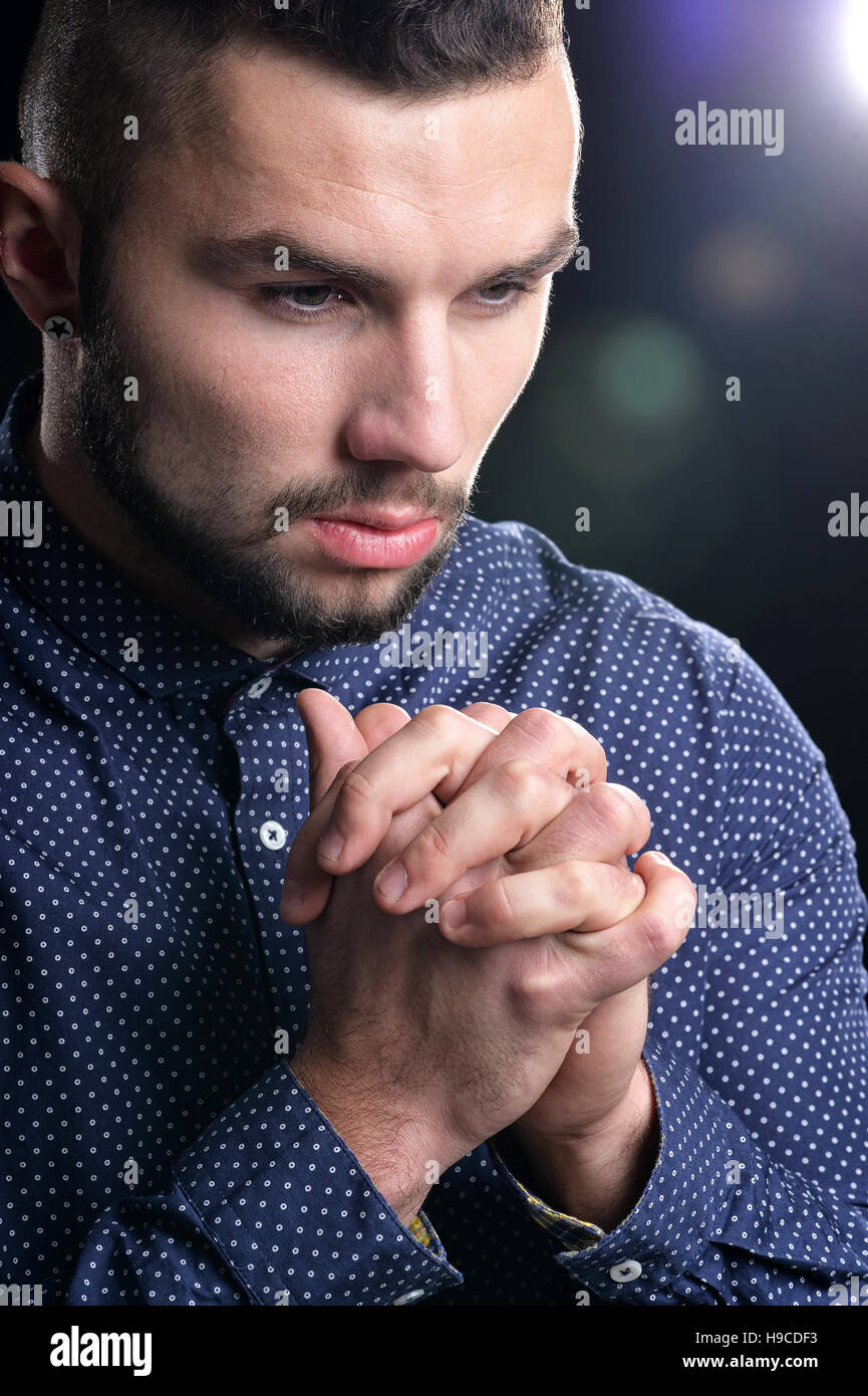 Young man praying Stock Photo - Alamy