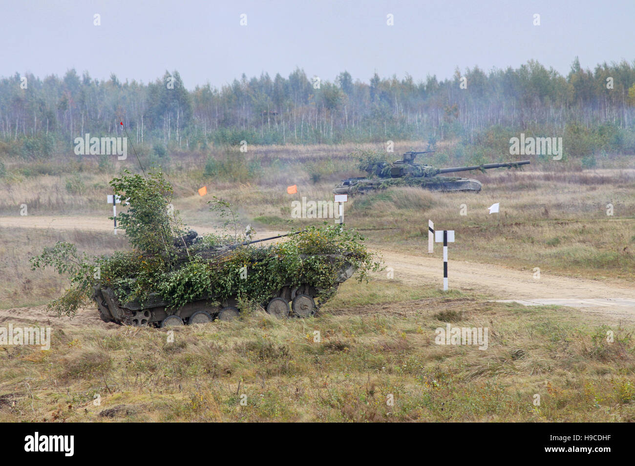Battle tank and armored infantry combat vehicler during military ...