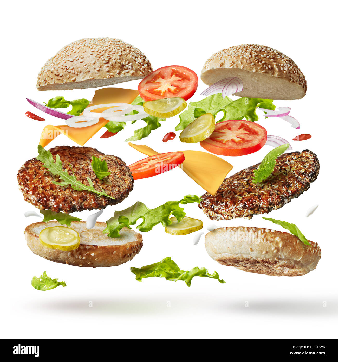 Two burgers with flying ingredients isolated on white background Stock ...