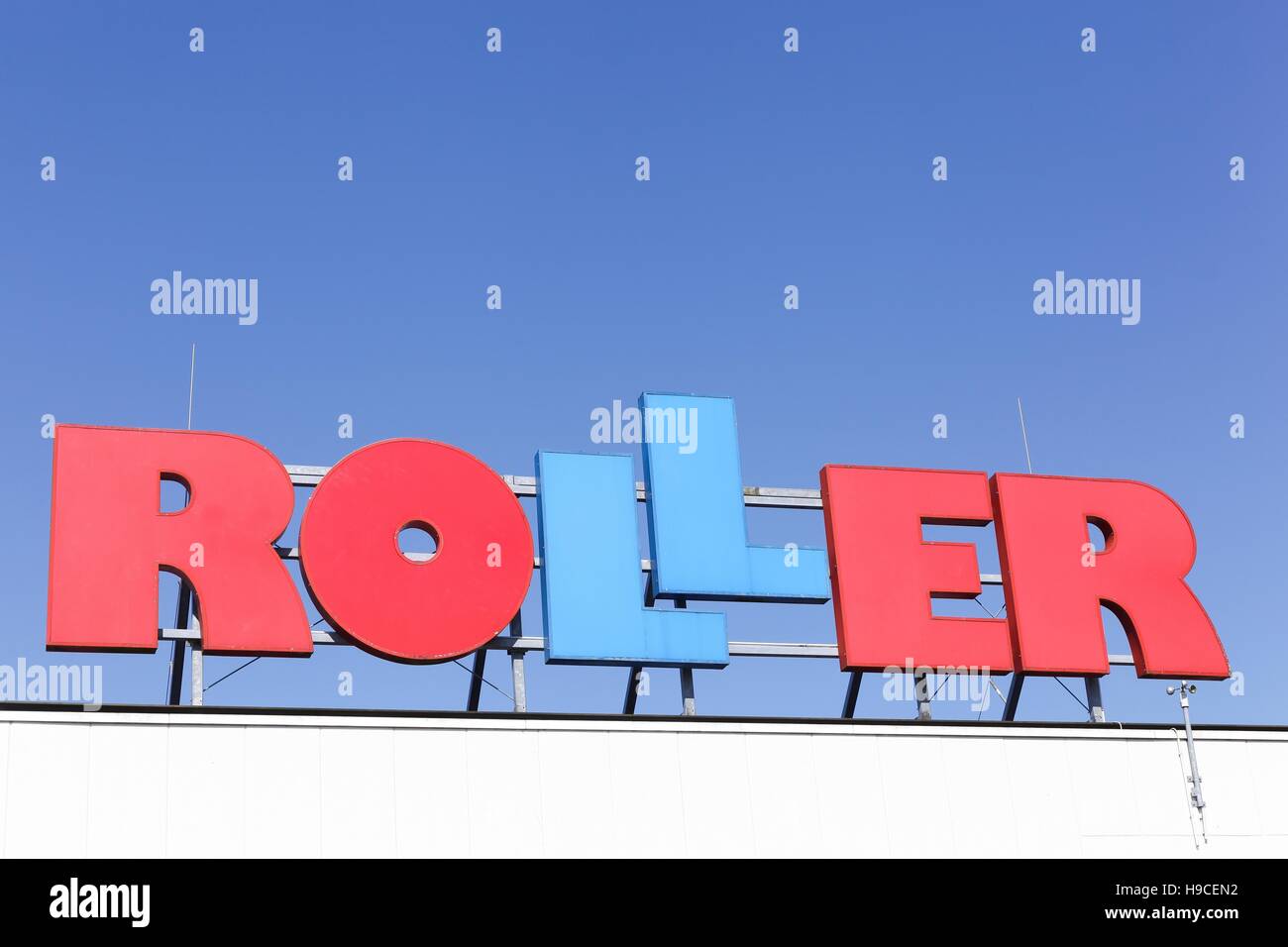 Roller logo on a building Stock Photo - Alamy