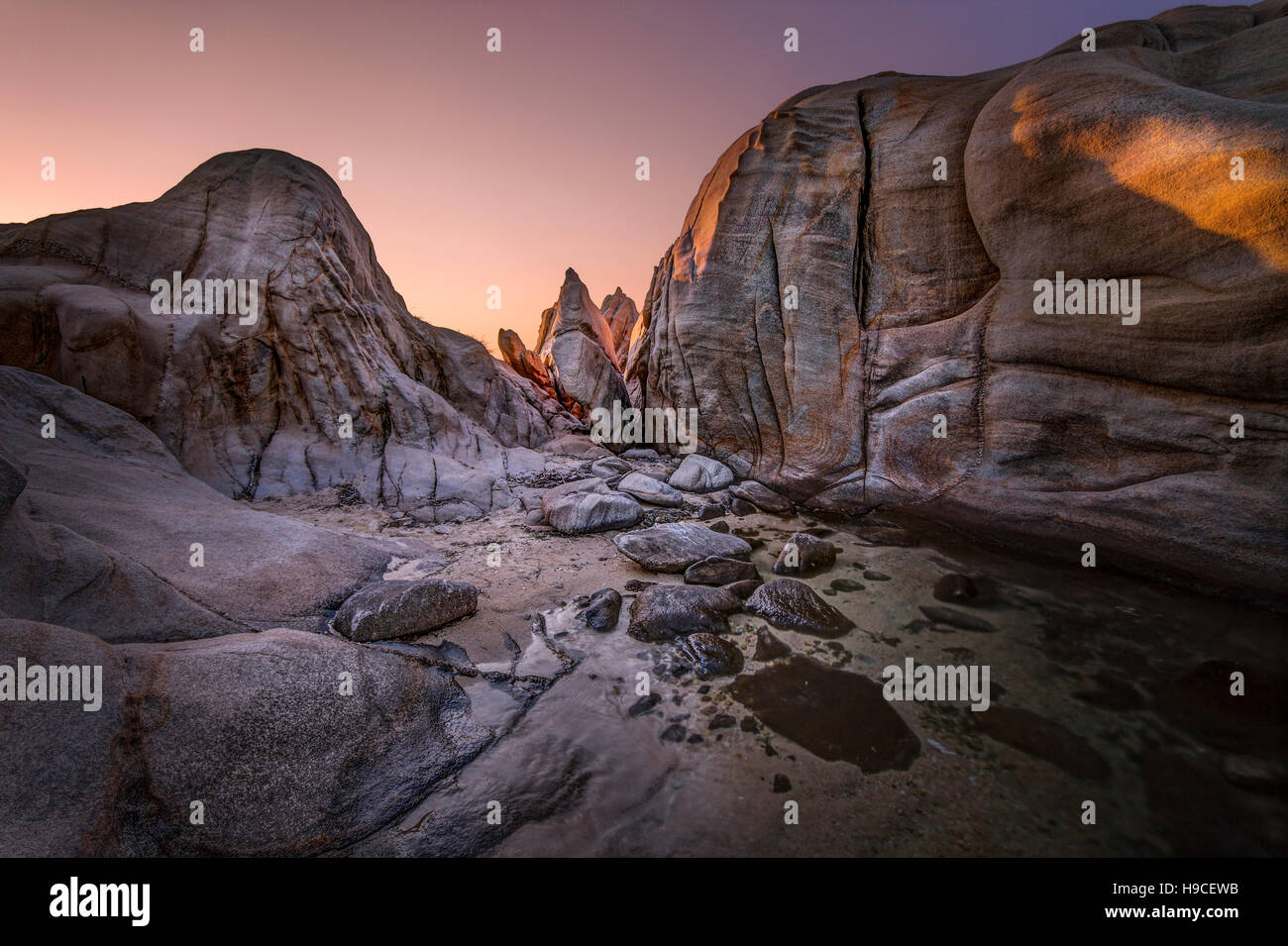A rocky beach on sunset Stock Photo - Alamy