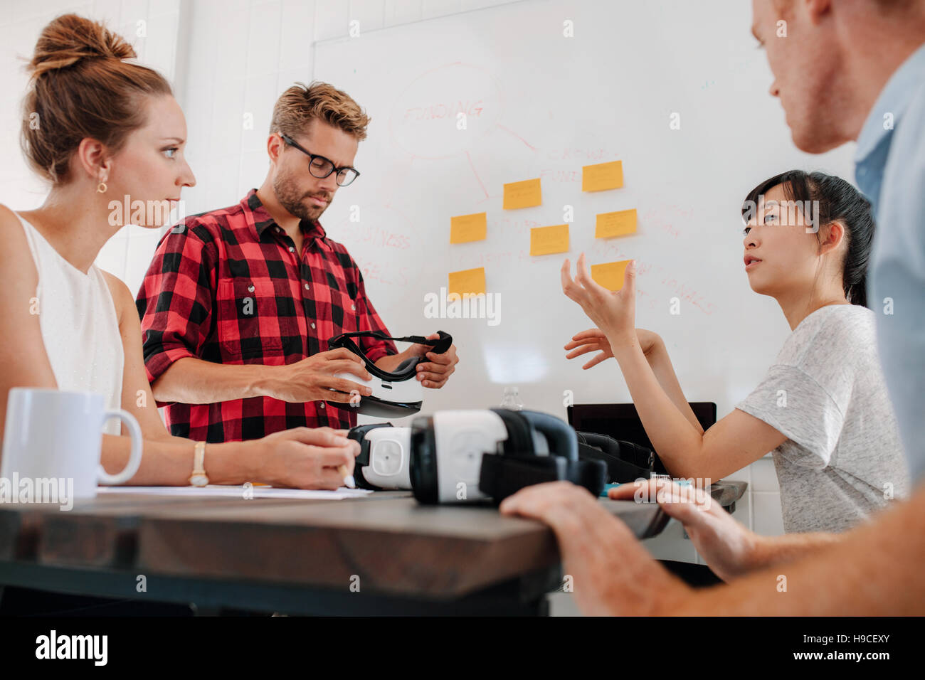 Group of young people meeting in conference room with augmented reality ...
