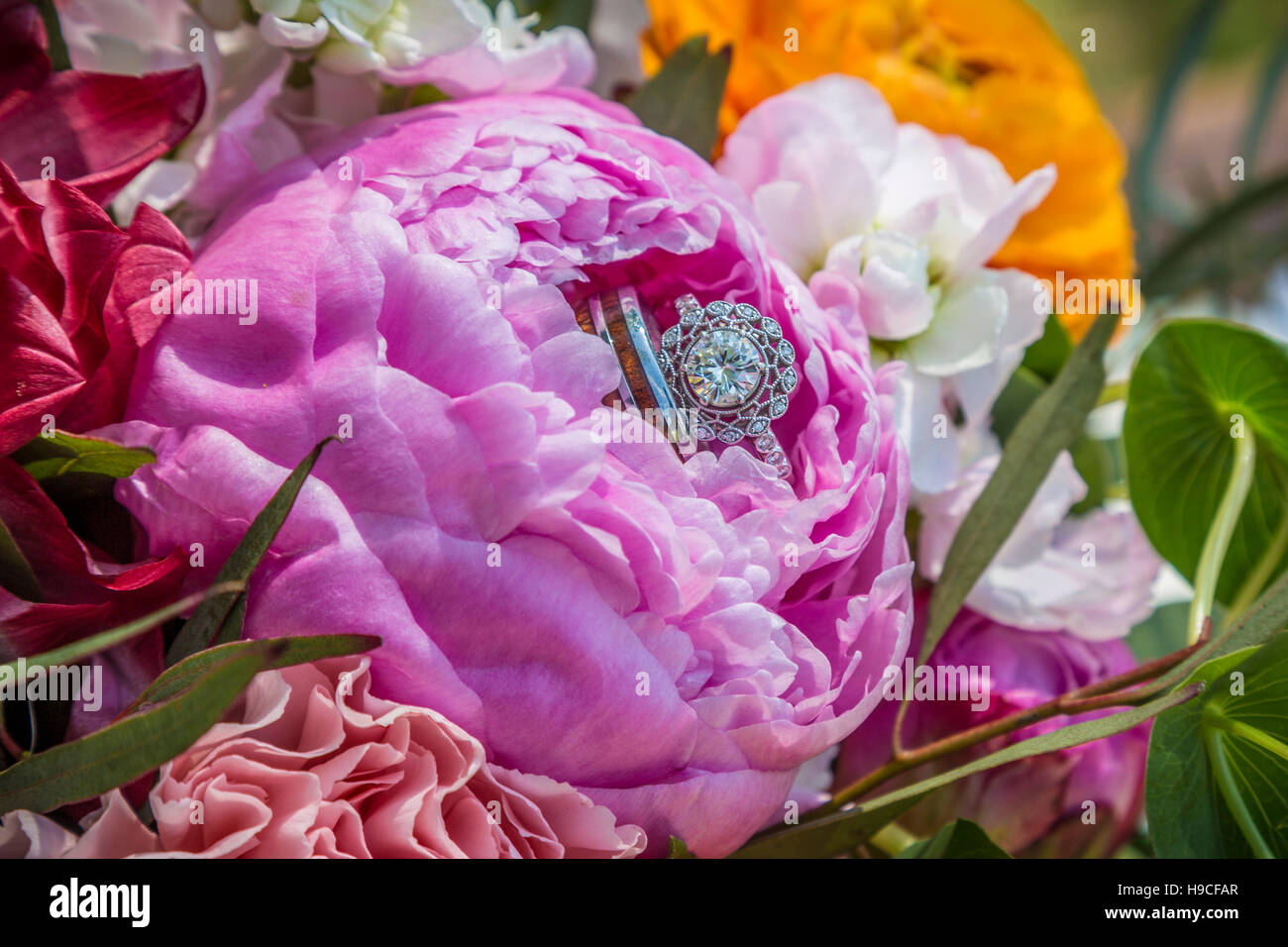 Wedding rings in bridal bouquet flowers Stock Photo - Alamy