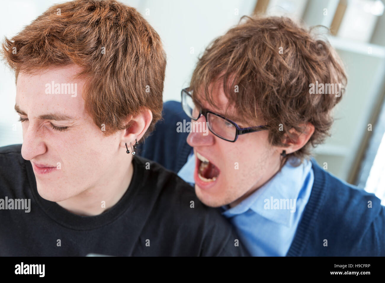 boss or colleague shouting in other's ear in the office workplace Stock ...