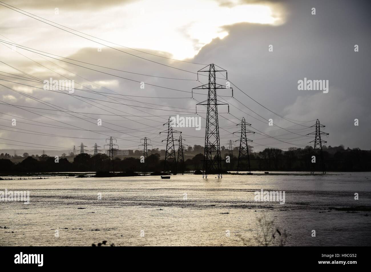Electricity pylons sit in flooded fields adjacent to Station Road ...