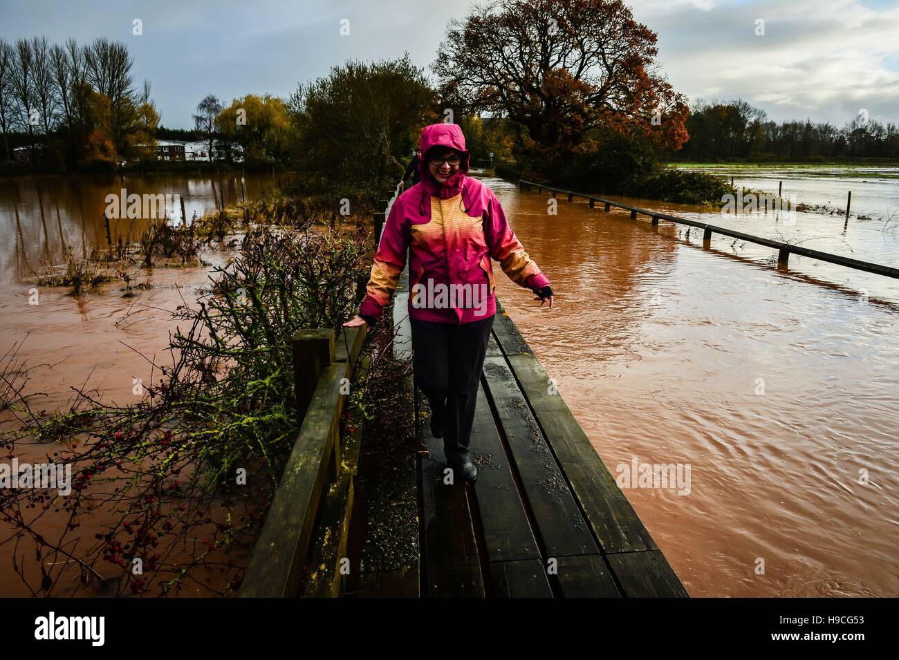 People venture out and carefully avoid deep flood water on Station Road ...