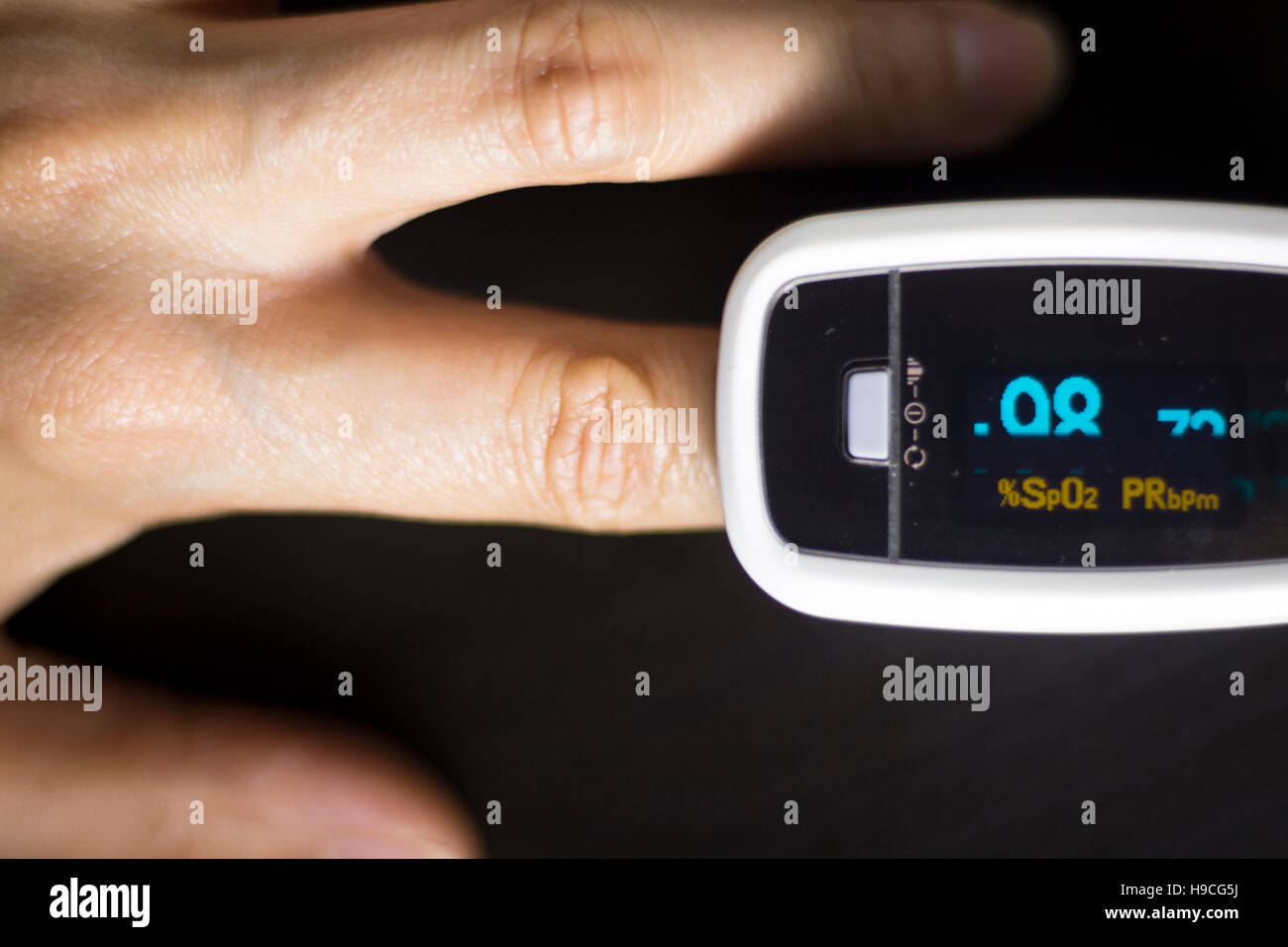 Portable hand held domestic cardiac finger pulse rate meter to show ...