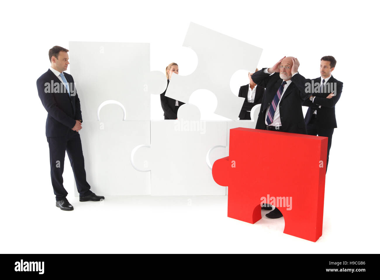 Group of business people assembling pieces of a puzzle isolated on ...