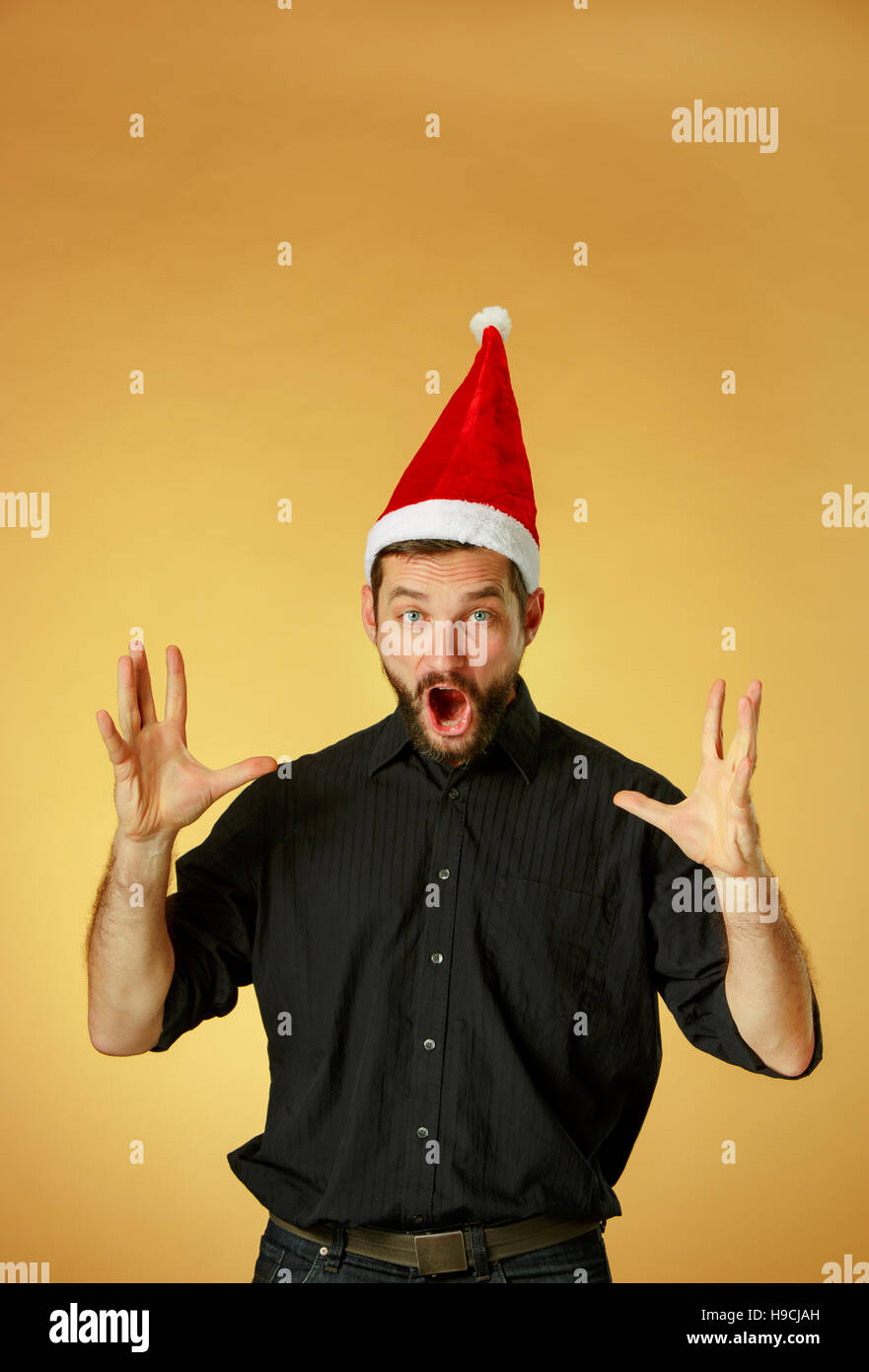 The screaming christmas man wearing a santa hat Stock Photo - Alamy