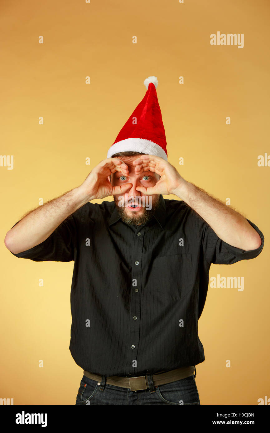 The Surprised christmas man wearing a santa hat Stock Photo - Alamy