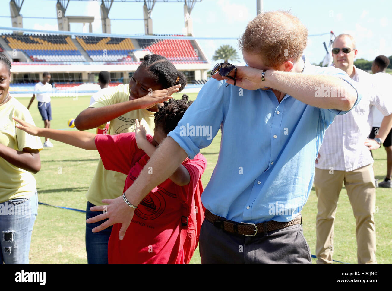 Prince Harry does the 'dab' as he meets school girls as he attends a ...