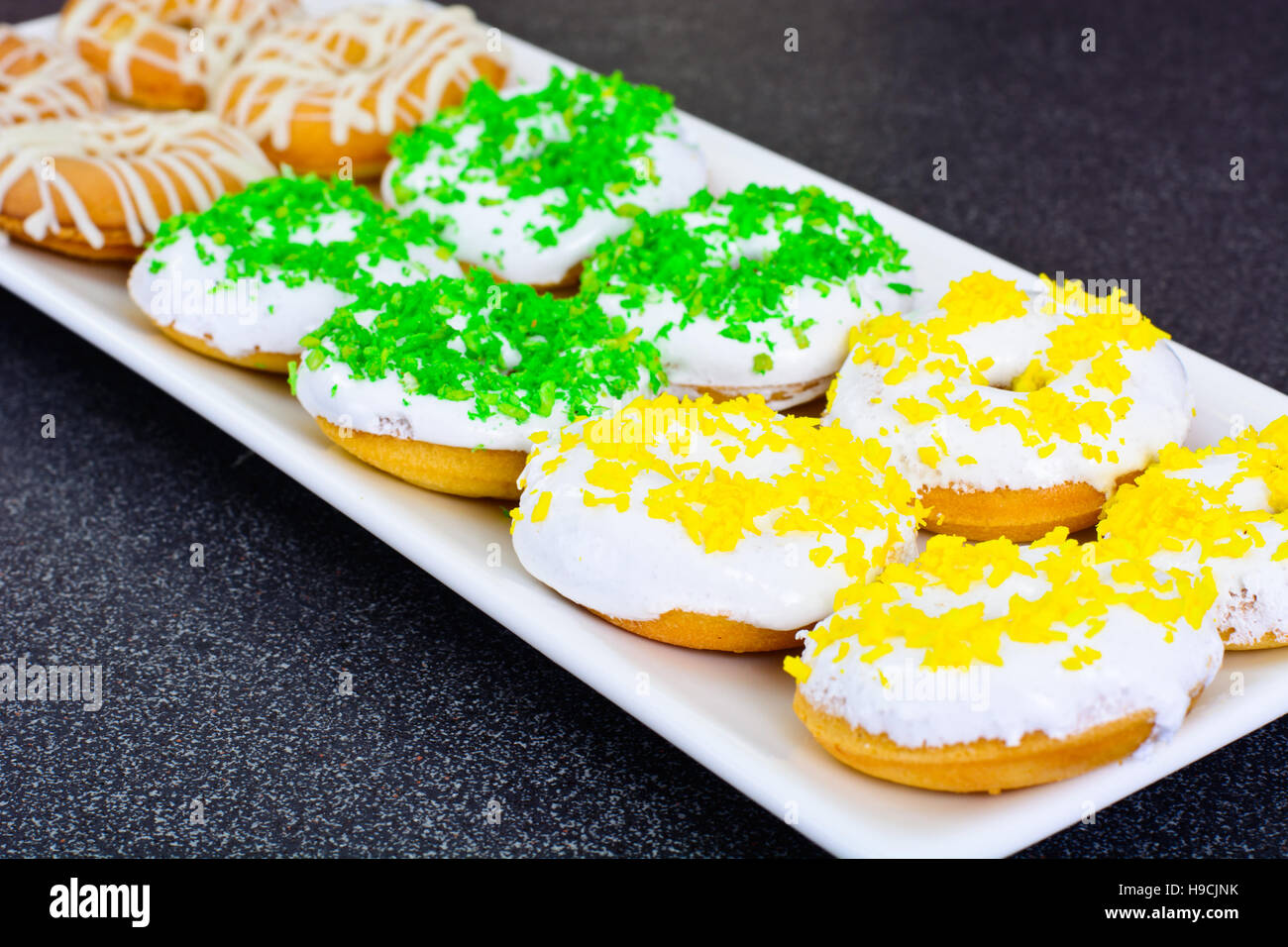 Donuts with Icing and Coconut Protein-Grained Color Stock Photo - Alamy