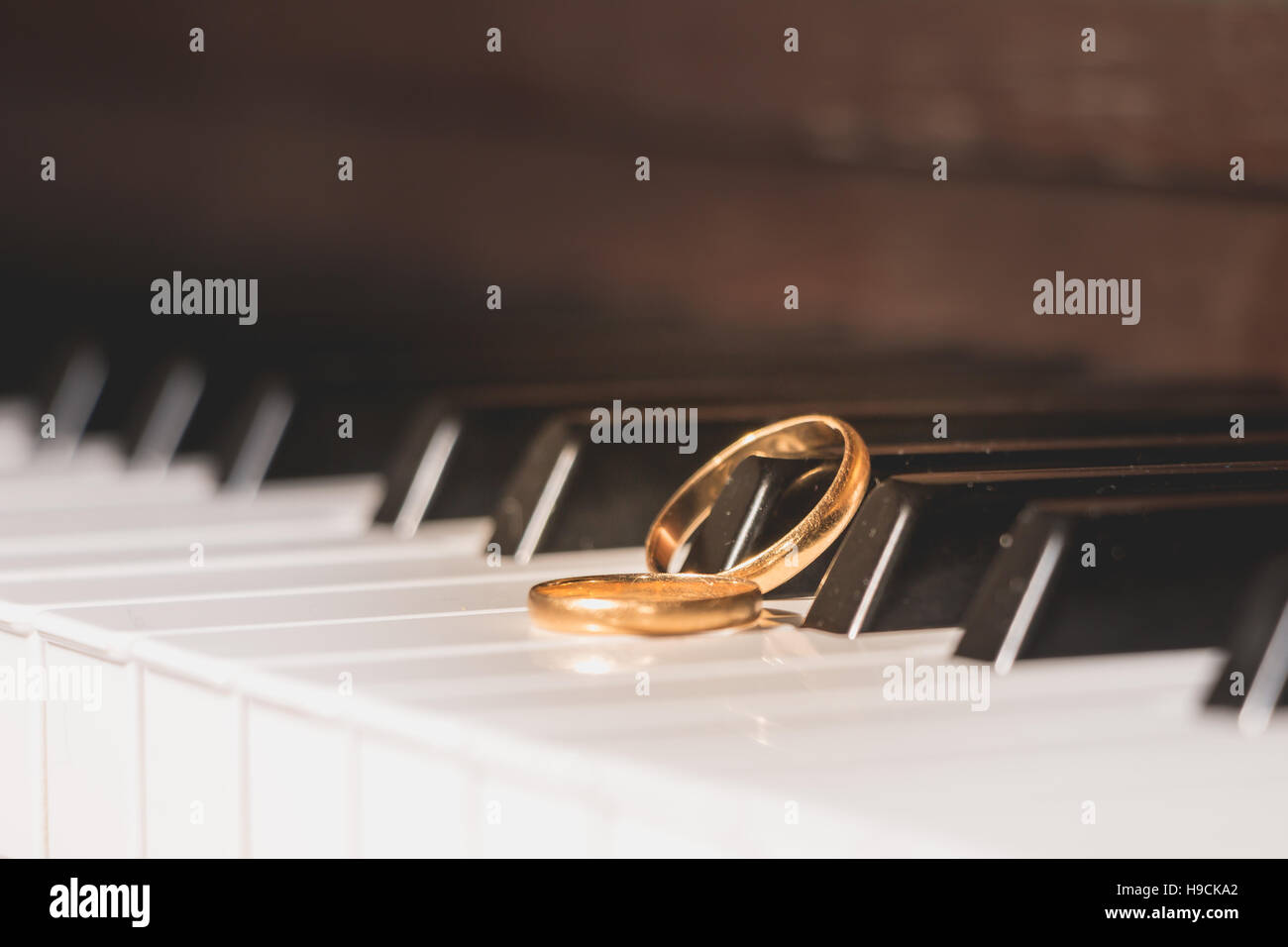 gold wedding rings on a piano key Stock Photo - Alamy