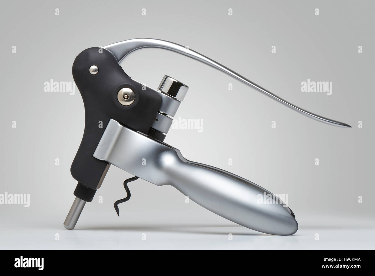 Closeup of a modern metal cork screw on Gray background Stock Photo - Alamy