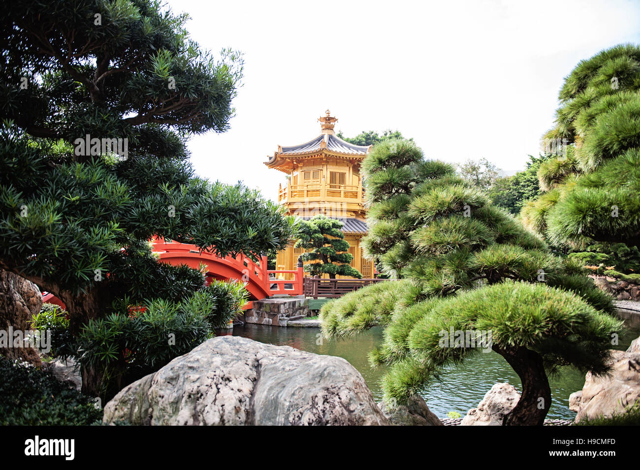 Yellow Pagoda with red bridge framed between green trees at Nan Lian ...