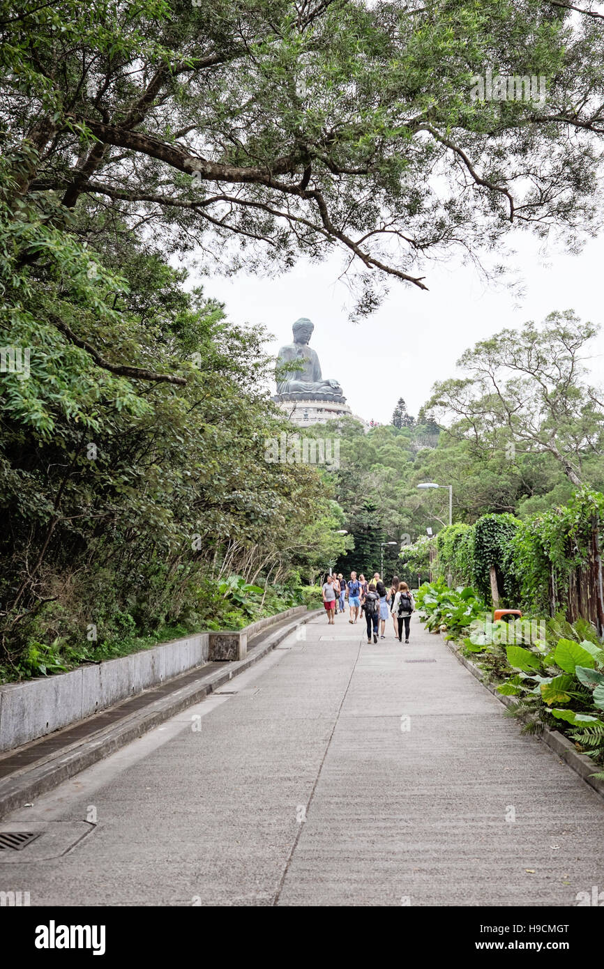 People walking on Path with Big Buddha (Tian Tan) in Background Stock ...