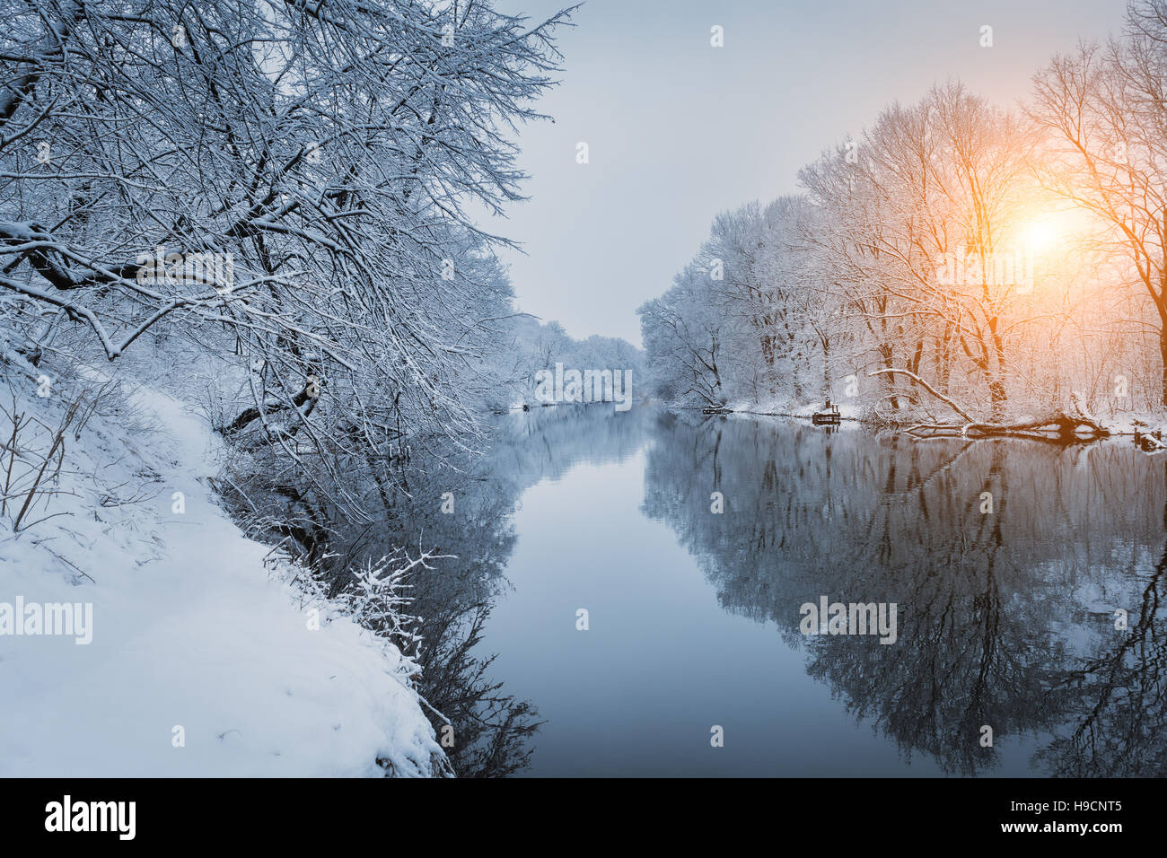 Winter forest on the river at sunset. Colorful landscape with snowy ...