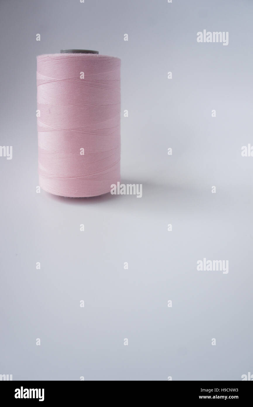 A pink cotton thread bobbin Stock Photo - Alamy