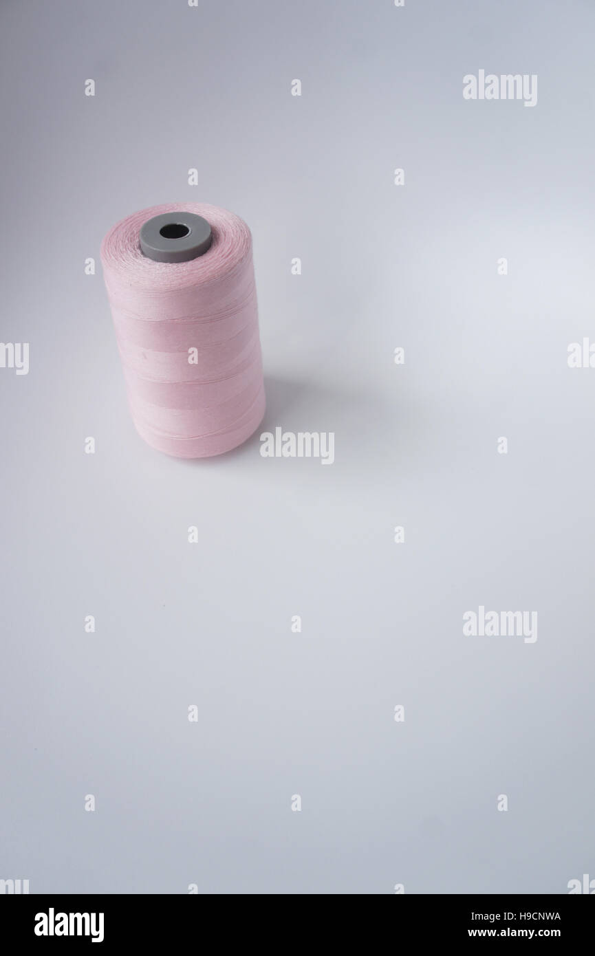 A pink cotton thread bobbin Stock Photo - Alamy