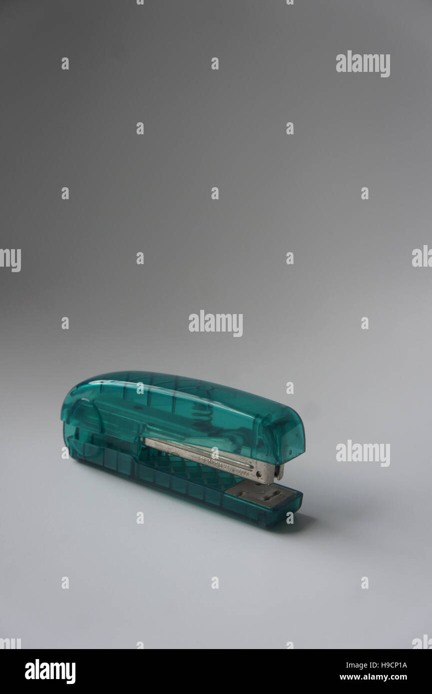 A green plastic stapler Stock Photo - Alamy