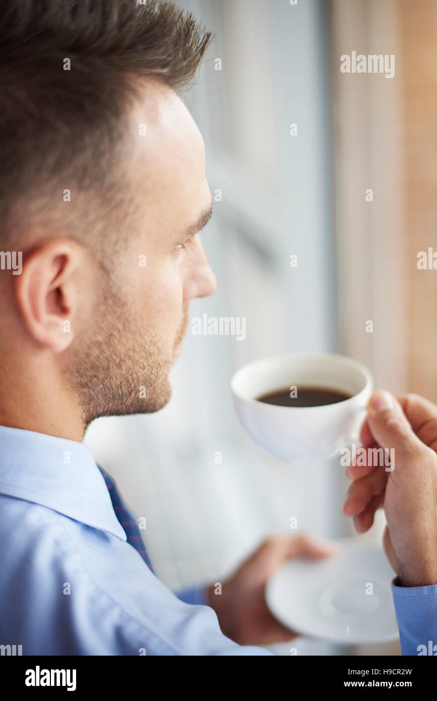 Rear view of man with cup of coffee Stock Photo - Alamy