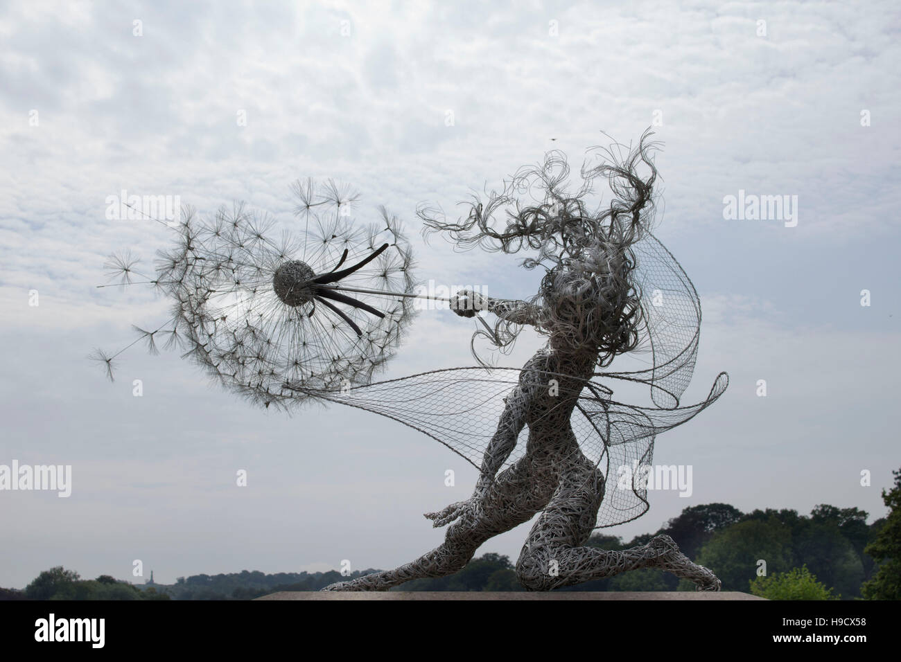 A metal statue fairy holding dandelion clock Stock Photo - Alamy