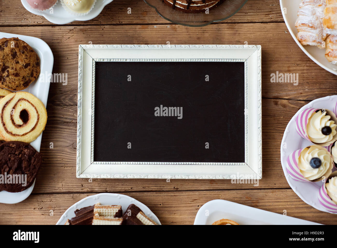 Picture frame and cookies, cupcakes and other treats. Copy space Stock ...