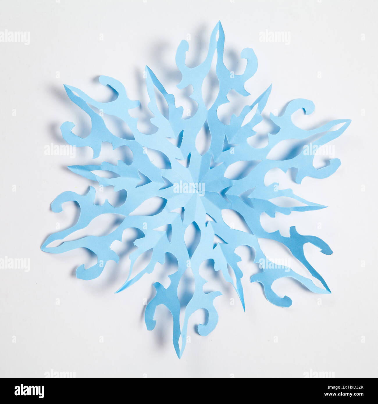 Fine paper snowflake cut out Stock Photo - Alamy