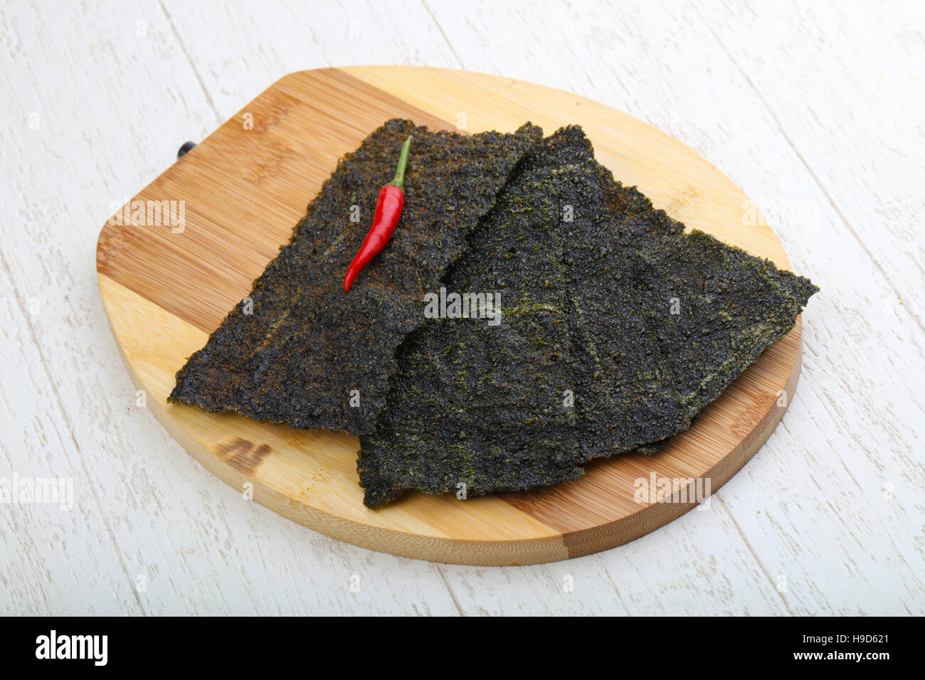 Spicy Nori seaweed sheets with pepper on wood Stock Photo - Alamy