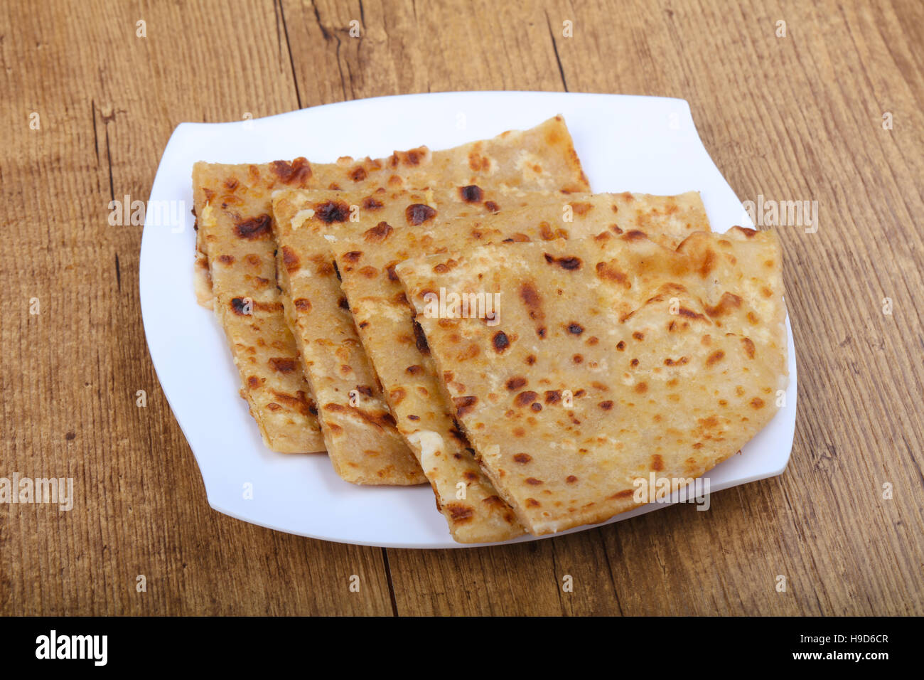 Indian bread roti on the plate in wood background Stock Photo - Alamy