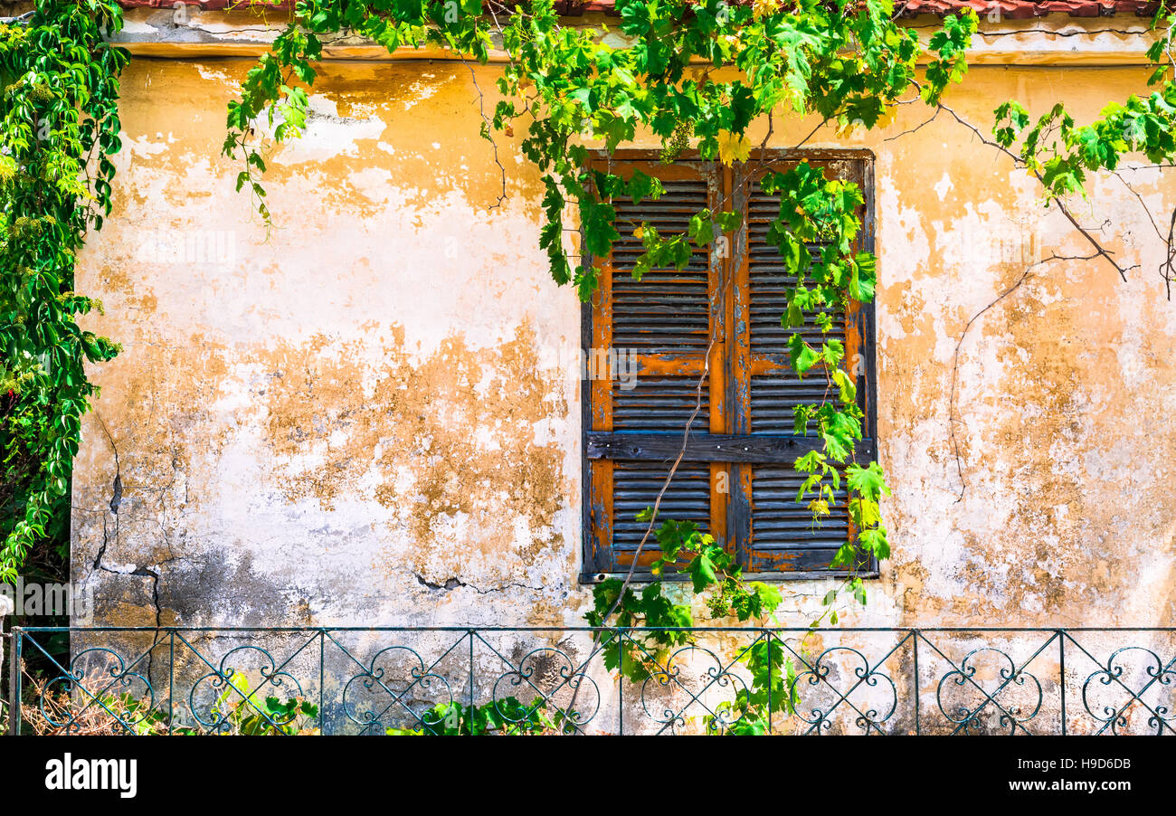 Traditional vintage Greek window of abandoned earth quake damaged home ...