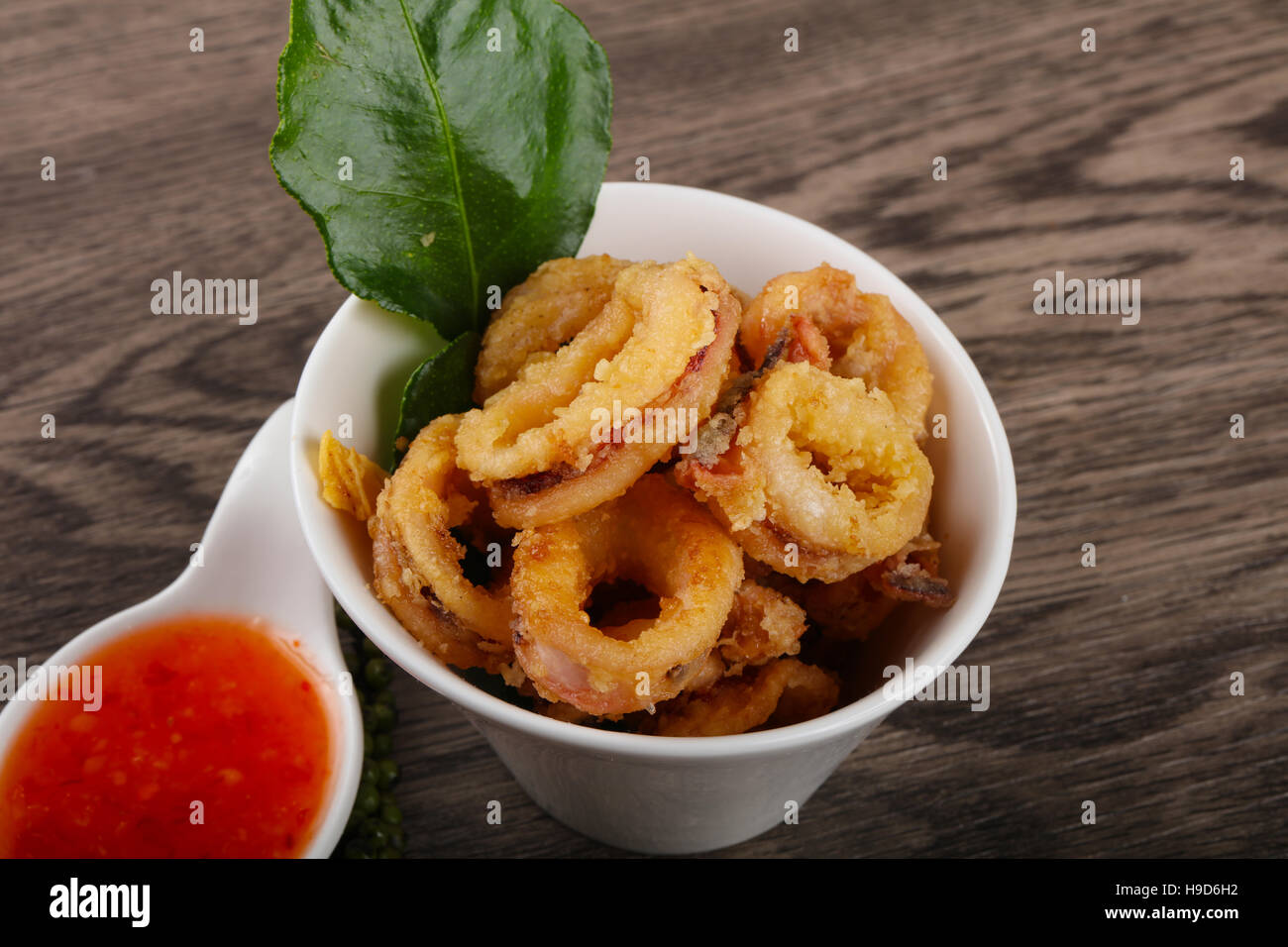Fried squid rings with hot spicy sauce Stock Photo - Alamy