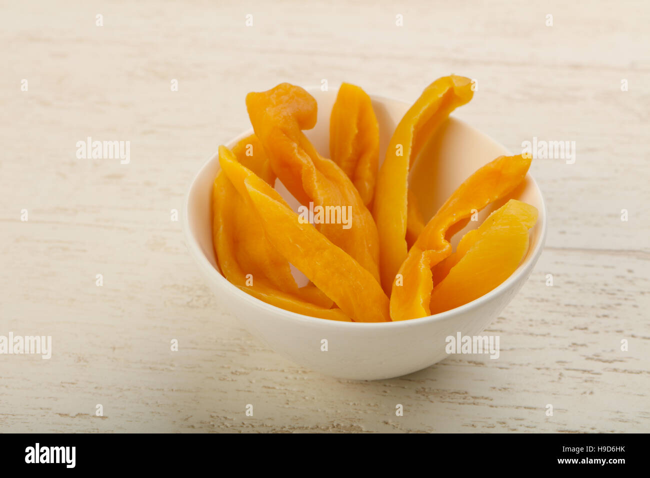 Dry mango chips heap in the bowl Stock Photo - Alamy